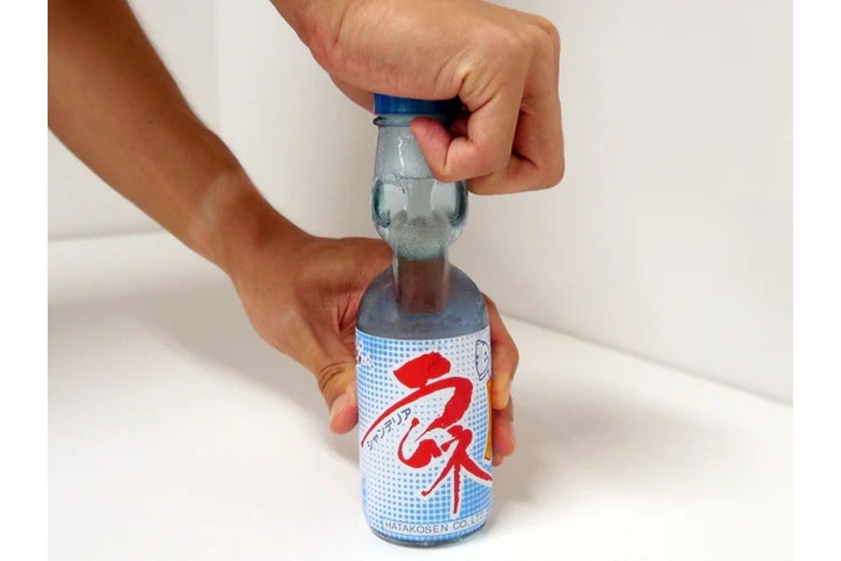 Press firmly on the plunger until the marble falls into the bottle